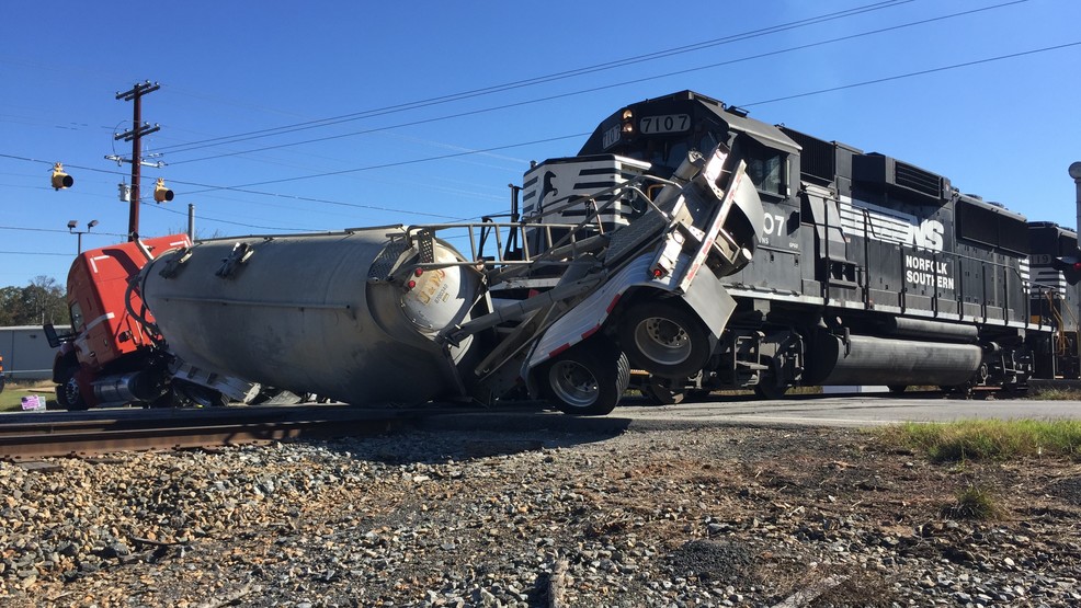 Tractor trailer stopped on the tracks, hit by train, blocks highway | WLOS